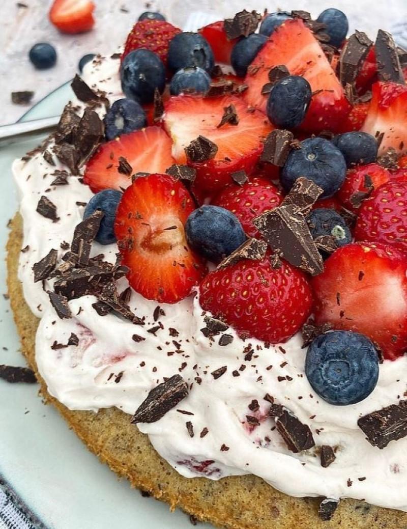 Nut cake with strawberry cream, fresh berries, and chocolate ...